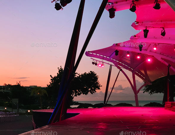 Stage at a tropical resort with pink neon lighting Stock Photo by ...