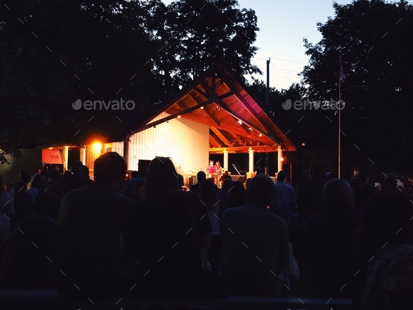 People are watching and listening to a small town outdoor concert at ...