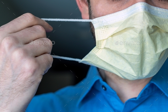 Putting on face mask, taking off face mask. Stock Photo by RLTheis