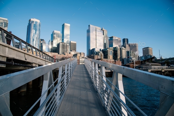 Point of view ramp up from waterfront pier dock at Seattle skyline ...