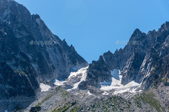 Jagged rock mountain peaks with melting glacier sheets. Stock Photo by ...