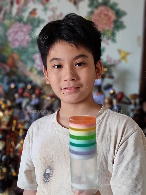 Portrait of an Asian gen z holding a colourful jelly pudding Stock ...