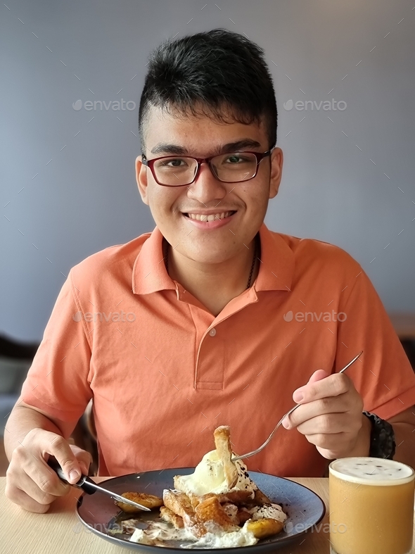 Portrait of an Asian gen z enjoying food Stock Photo by weewendy ...