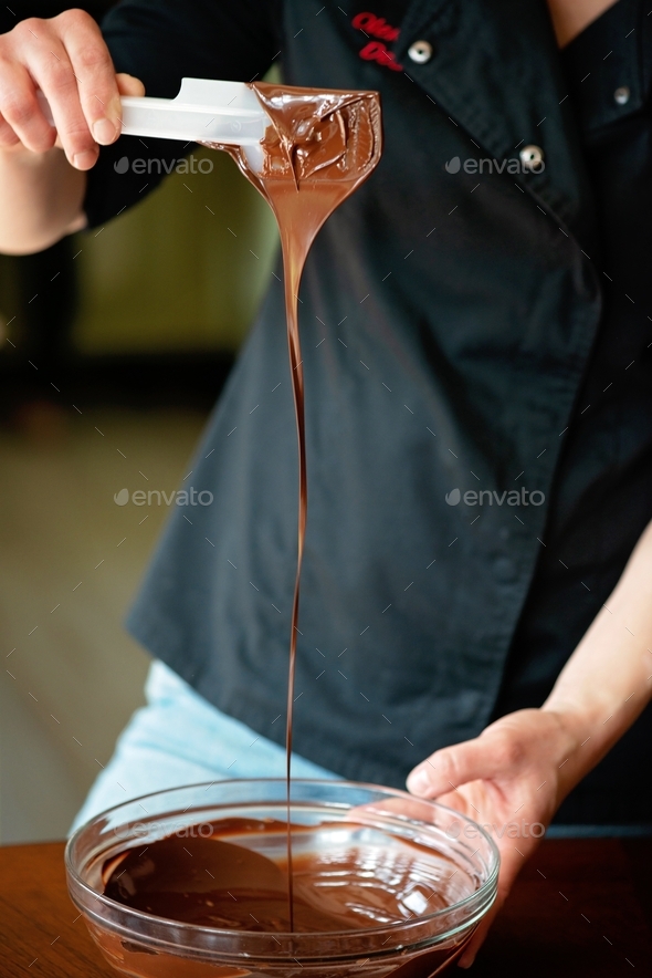 Pastry chef tempering hot dark chocolate. Cooking desserts. Stock Photo ...