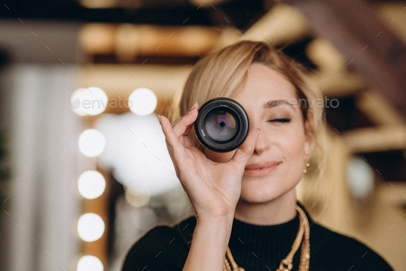 female photographer looking through the lens aperture Stock Photo by ...