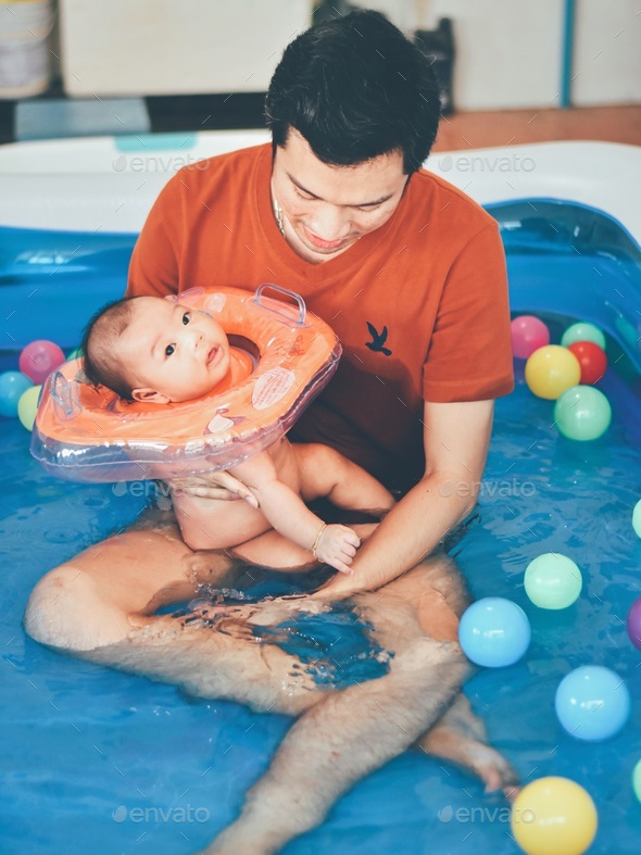 Kid boy playing in small baby pool.infant swim and splash. Happy baby ...
