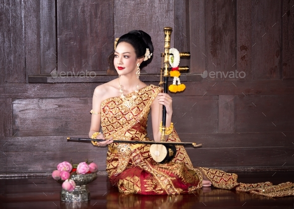 Asia woman wearing traditional Thai dress, The costume of the national dress of ancient Thailand ...