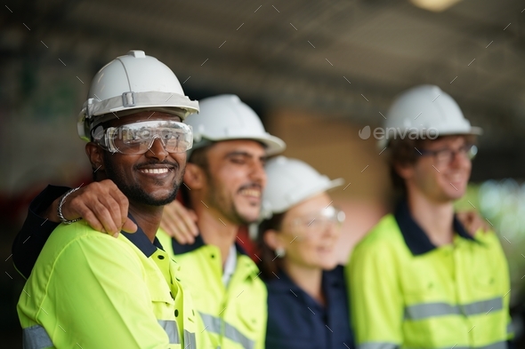 Closeup side view of early 30's male employee at a factory plant ...