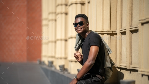 Young smiling attractive black man lifestyle portrait. Stock Photo by ...