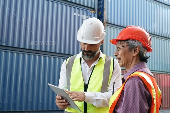 Engineer and worker in cargo port checking containers Stock Photo by ...
