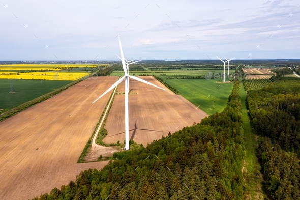 aerial view of a large three blade industrial wind turbine generating ...