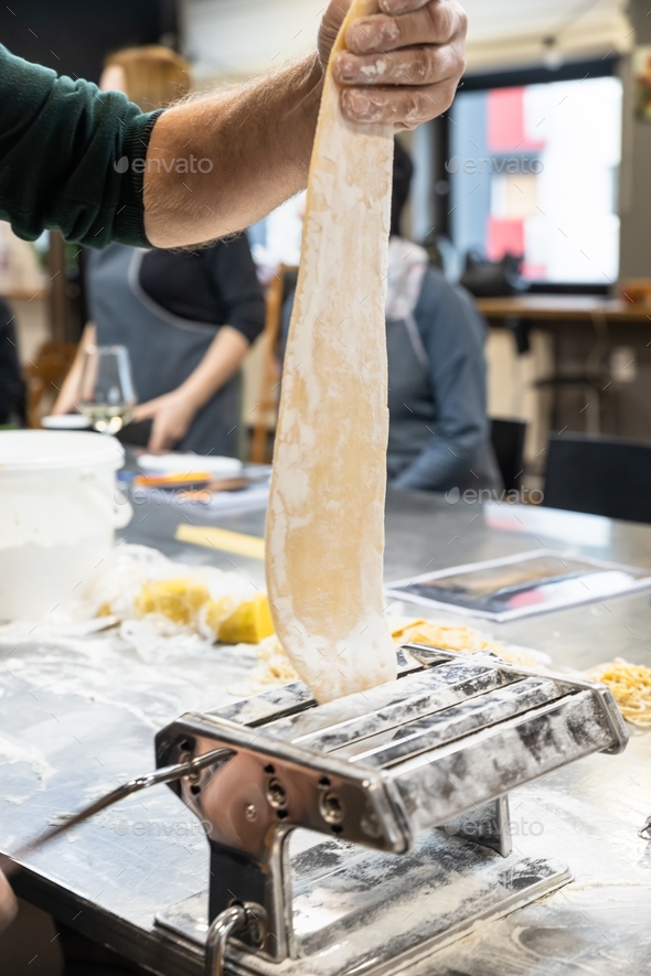 The process of making homemade pasta using a pasta machine. Stock Photo ...