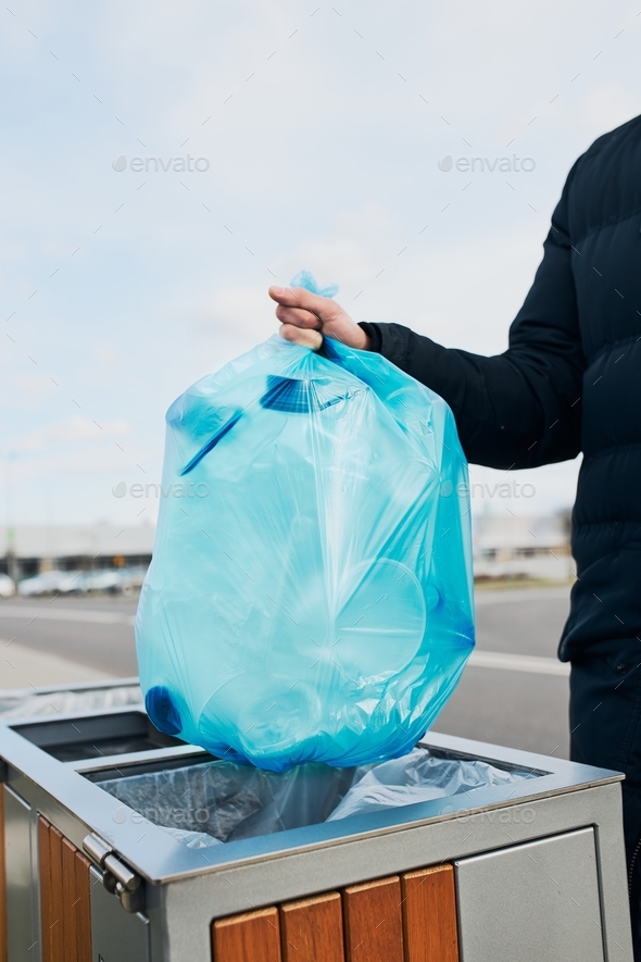Man throwing a bag full of plastic waste to trash. Plastic waste to ...