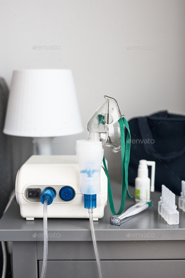 Nebuliser with breathing mask and medicines on bedside table Stock ...