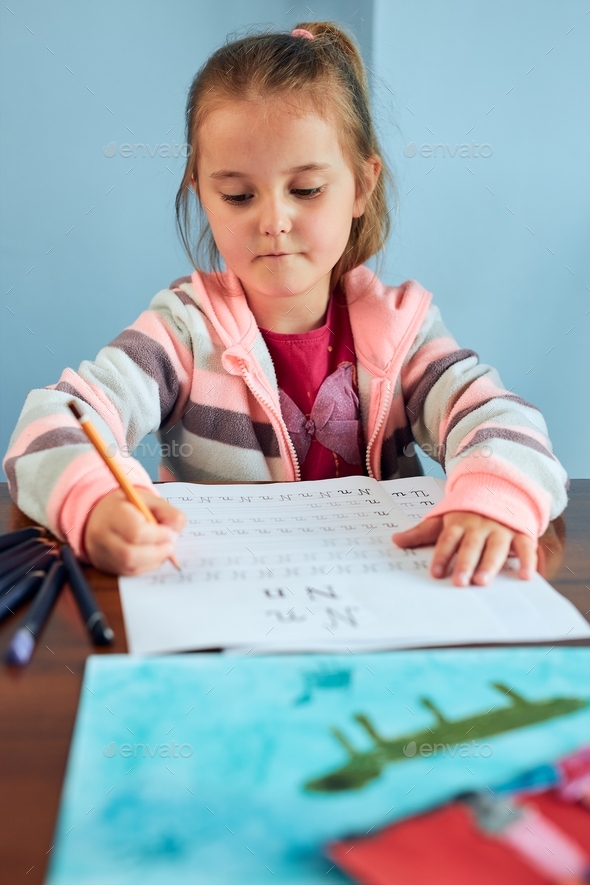 Little girl preschooler learning to write letters at home. Kid using ...