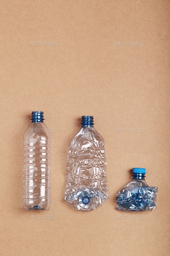 Plastic waste. Squashed empty plastic bottles put in a row. Collecting ...