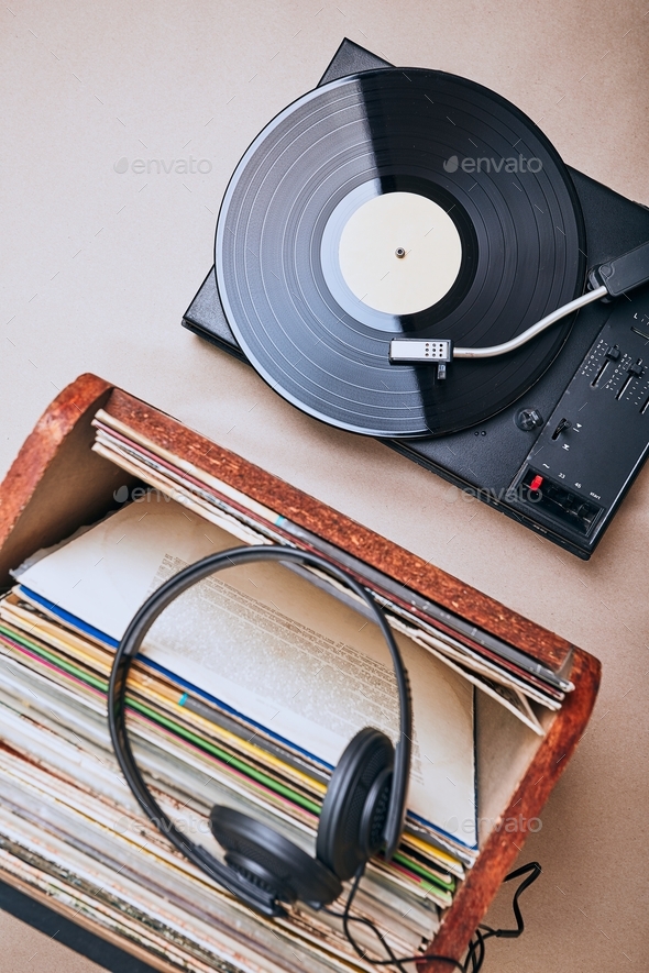 Stack of black vinyl records, turntable vinyl player and headphones ...