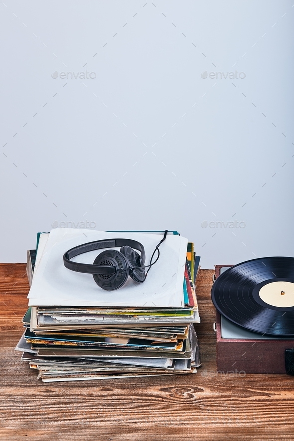 Stack of many black vinyl records, turntable vinyl player and ...