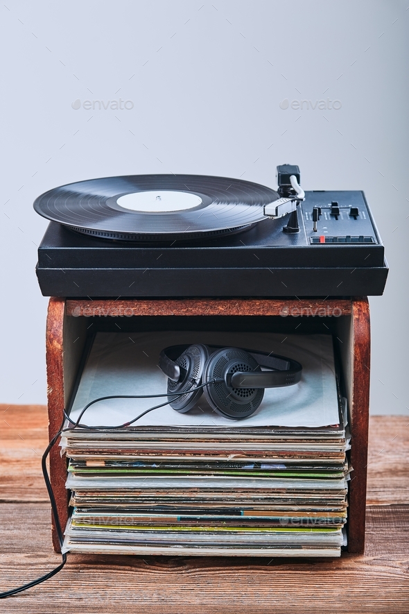Stack of vinyl records, turntable vinyl player and headphones. Classic ...