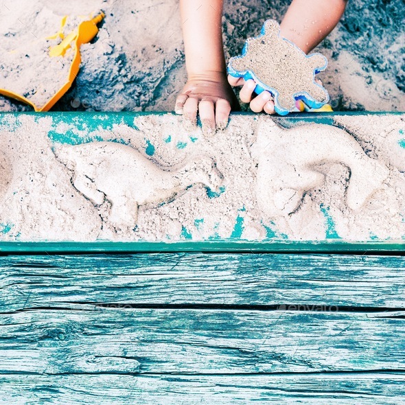 Kid creating animals forms from sand. Playing in a playground. Creative ...