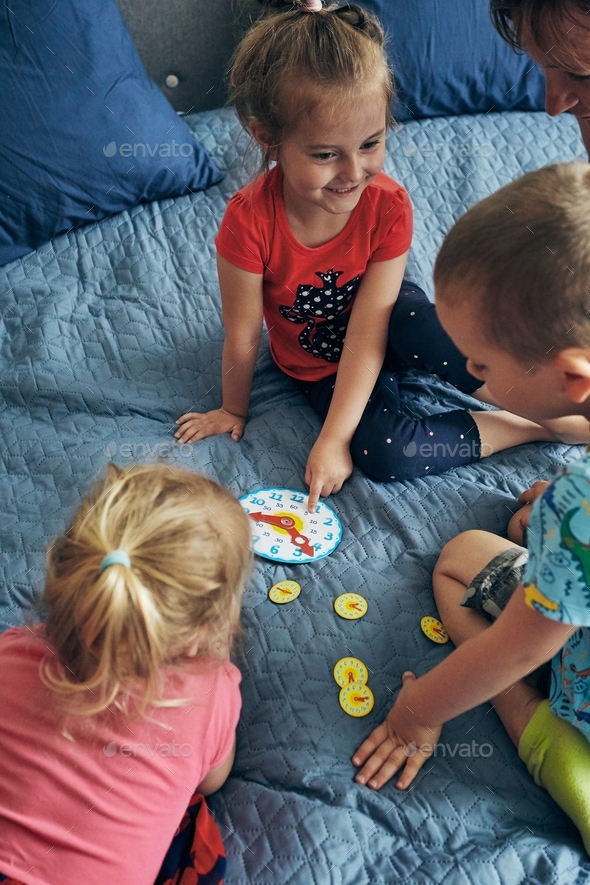 Kids learning how to tell time from clock and set the hands in the ...