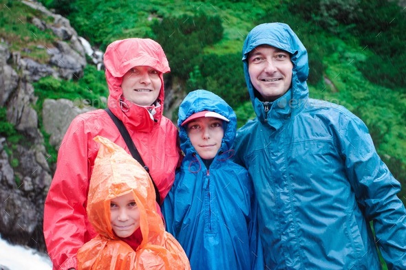 Family trip in mountains on rainy day. Poor weather. Summer vacation ...