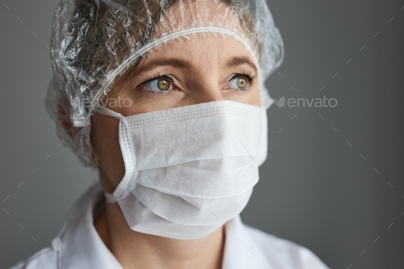 Woman wearing the uniform, cap and mask to avoid virus infection and to ...