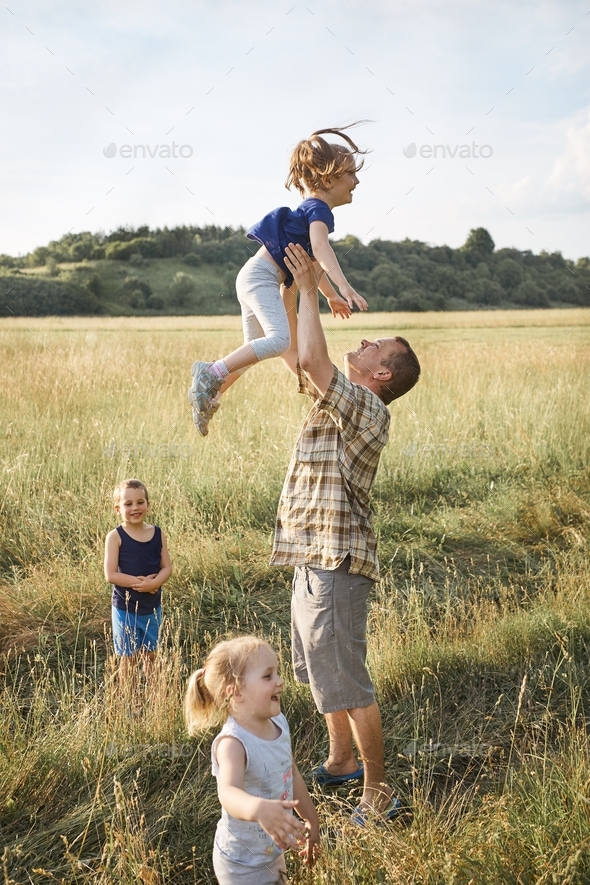 Father tossing little girl in the air Stock Photo by przemekklos ...
