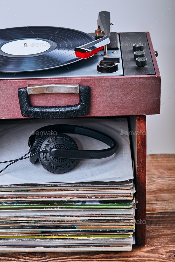 Stack of black vinyl records, turntable vinyl player and headphones ...