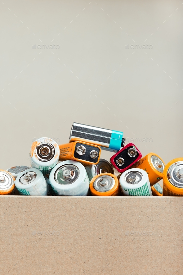Discharged batteries in cardboard box. Collecting used batteries to ...
