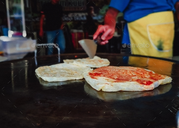 Making of Roti Canai or Roti Prata famous Indian margarine flatbread in ...