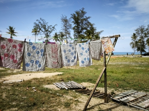 drying the rags under the hot sun at the beach Stock Photo by ellinnur