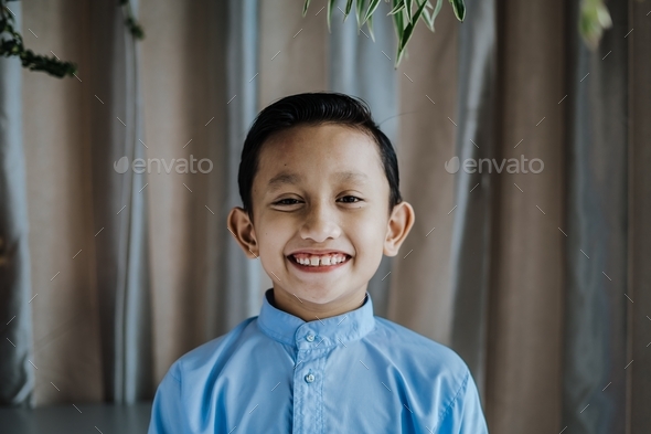 happy young boy smiling while wearing malay traditional "baju melayu ...