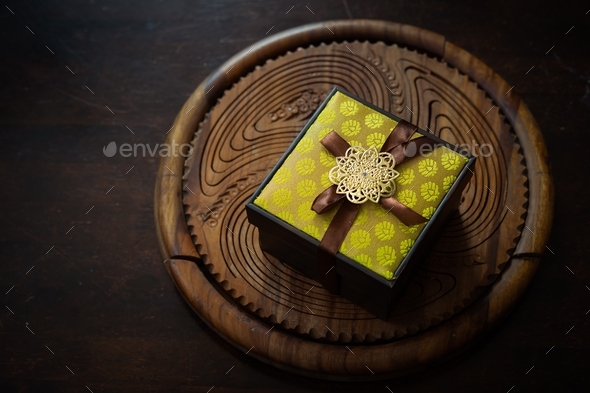 yellow songket box wrapped in ribbon on traditional handcrafted ...