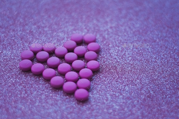 Pink purple medicine in a heart shape on a glitter background. Stock ...