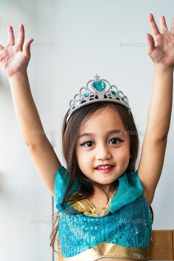 Portrait of a little girl dressed in arabian princess costume against ...