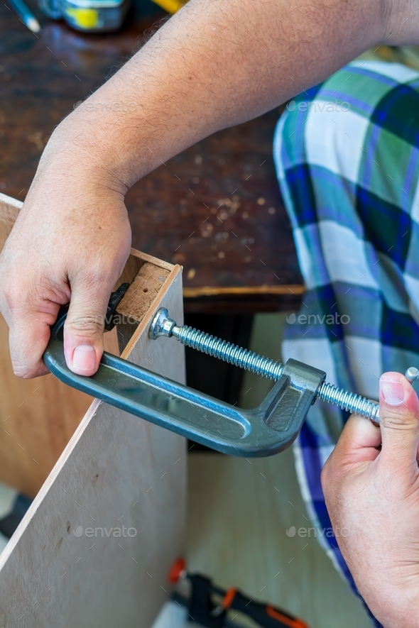 Woodworking. Woodworking project on a workbench, with c-clamps and bar ...