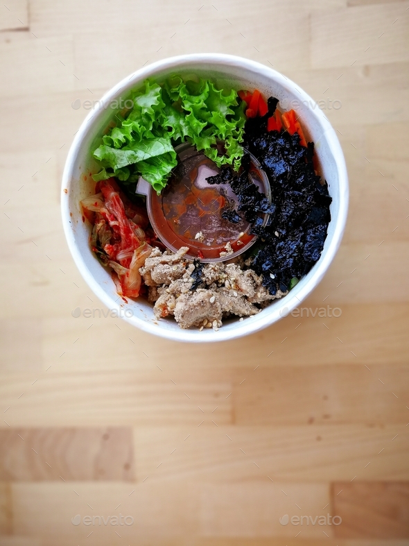 top view of Korean Bibimbap in a take out container Stock Photo by ellinnur