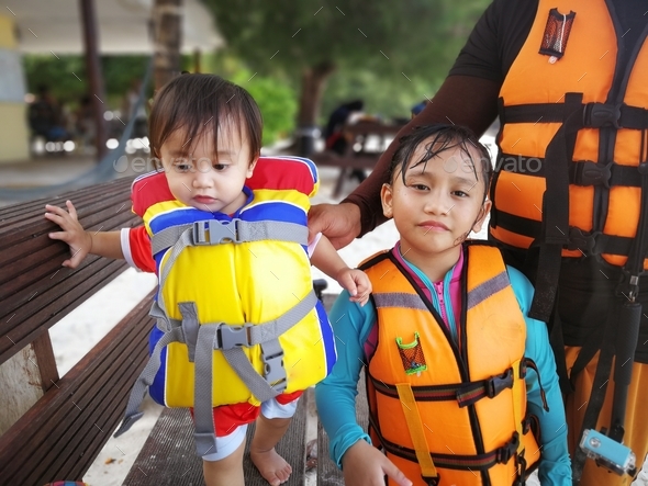 children wearing life jackets. baby toddler and little girl. Stock ...