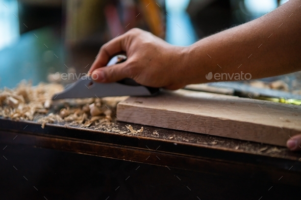 using chisel to sand the wooden plank Stock Photo by ellinnur | PhotoDune