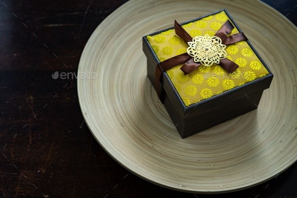 yellow songket box wrapped in ribbon on traditional handcrafted ...