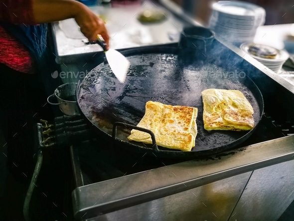 Making of Roti Canai or Roti Prata famous Indian margarine flatbread in ...