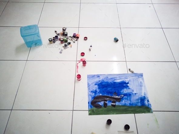Wet artwork with messy colouring on the floor. Stock Photo by ellinnur