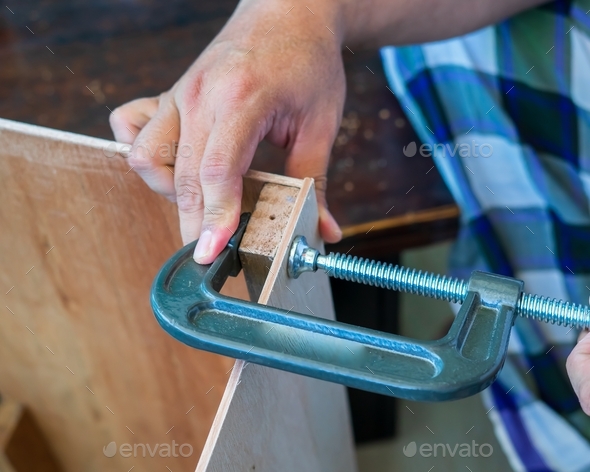 Woodworking. Woodworking project on a workbench, with c-clamps and bar ...