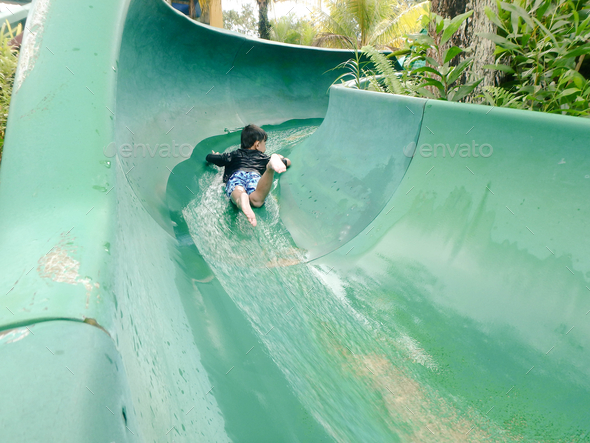young boy on water slide upside down and moving backwards Stock Photo ...