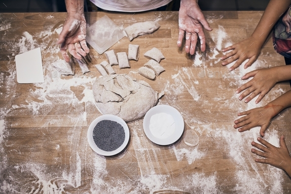 Hands kneading dough. People making dough for bread during bread making ...