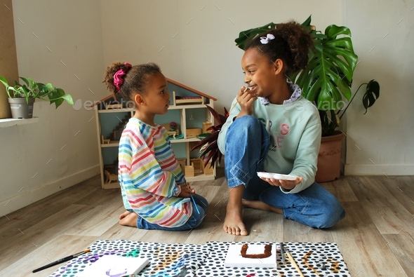 Siblings (mixed race) drawing and painting (paintbrush) and colorful ...