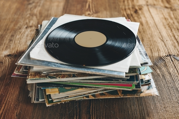 Stack of vinyl records. Listening to music from record. Playing music ...