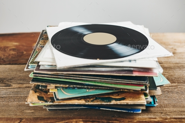 Stack of vinyl records. Listening to music from LP record. Playing ...
