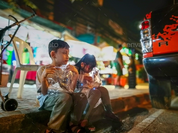 children eating at the roadside near the night market Stock Photo by ...